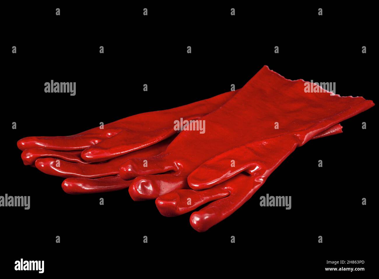Pair of the red rubber gloves, isolated on black background Stock Photo ...