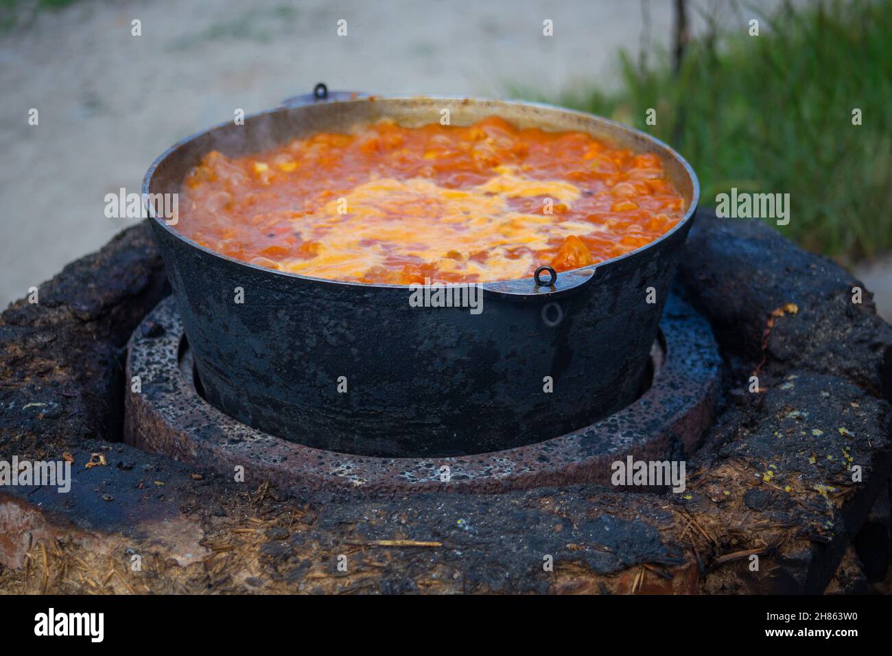 Large cauldron with a fluffy soup on the street Stock Photo - Alamy
