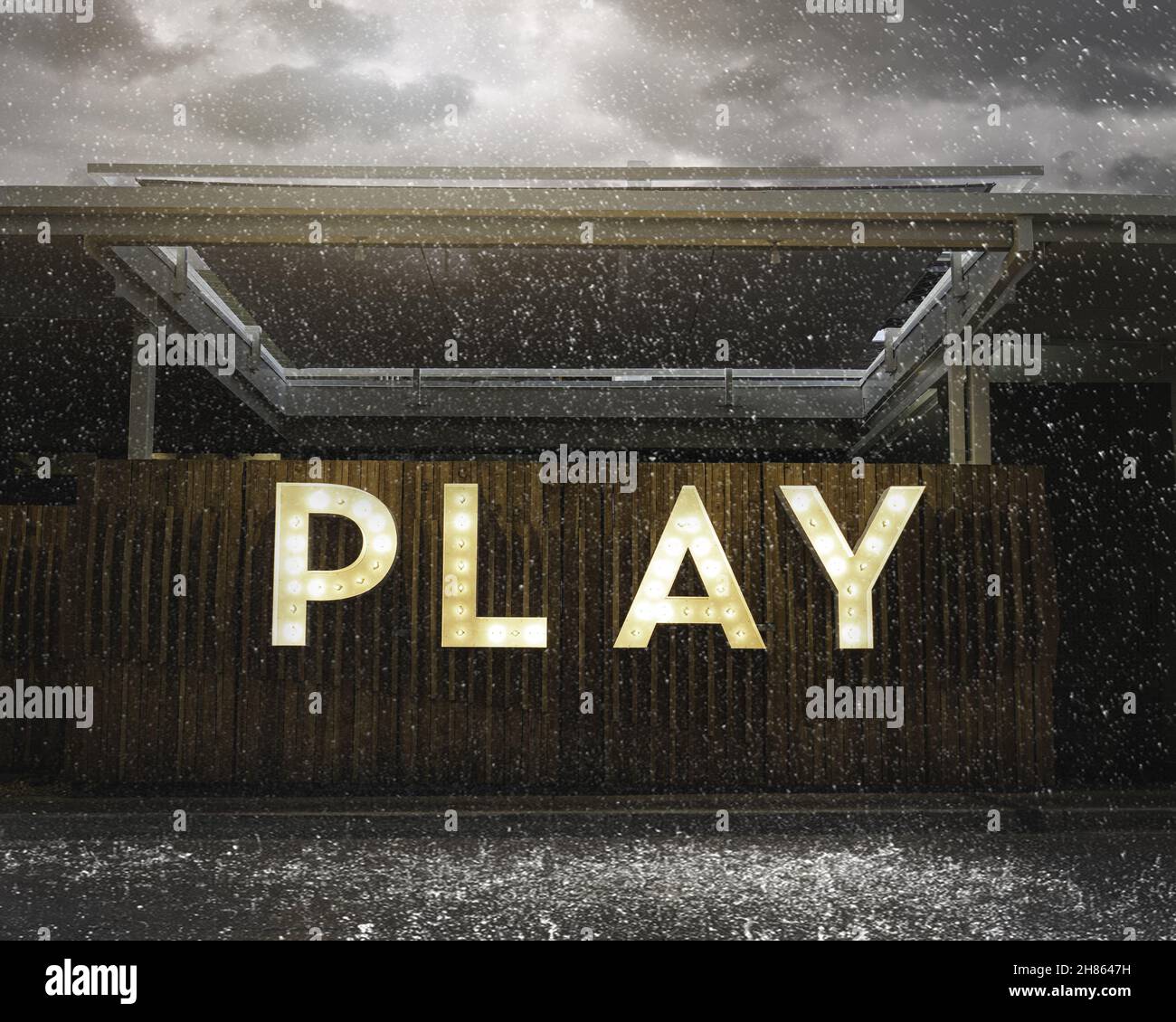 The word "PLAY" in the wall on a rainy day- play in the rain concept ...
