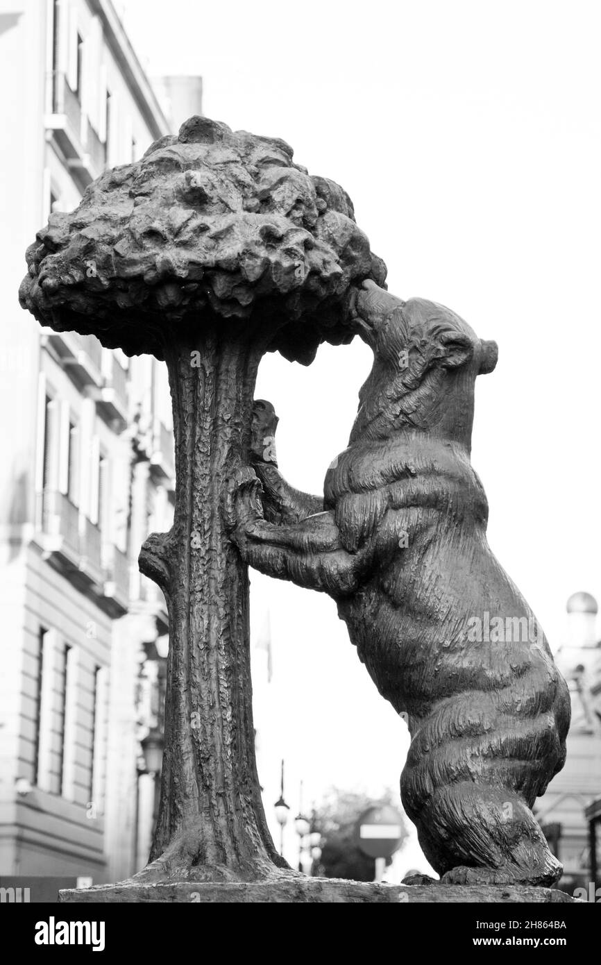 A vertical grayscale shot of the Bear and the Madrono Tree sculpture in ...