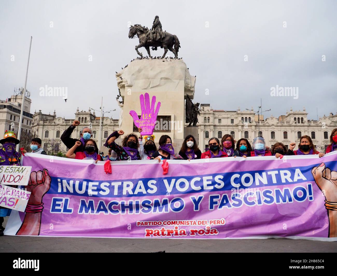 "Our voices against machismo and fascism" can be read on a banner when ...