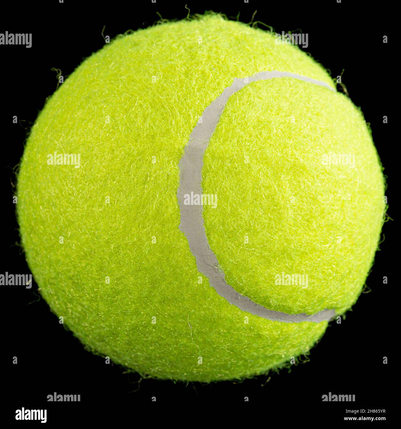 Green tennis ball, isolated on black background Stock Photo - Alamy