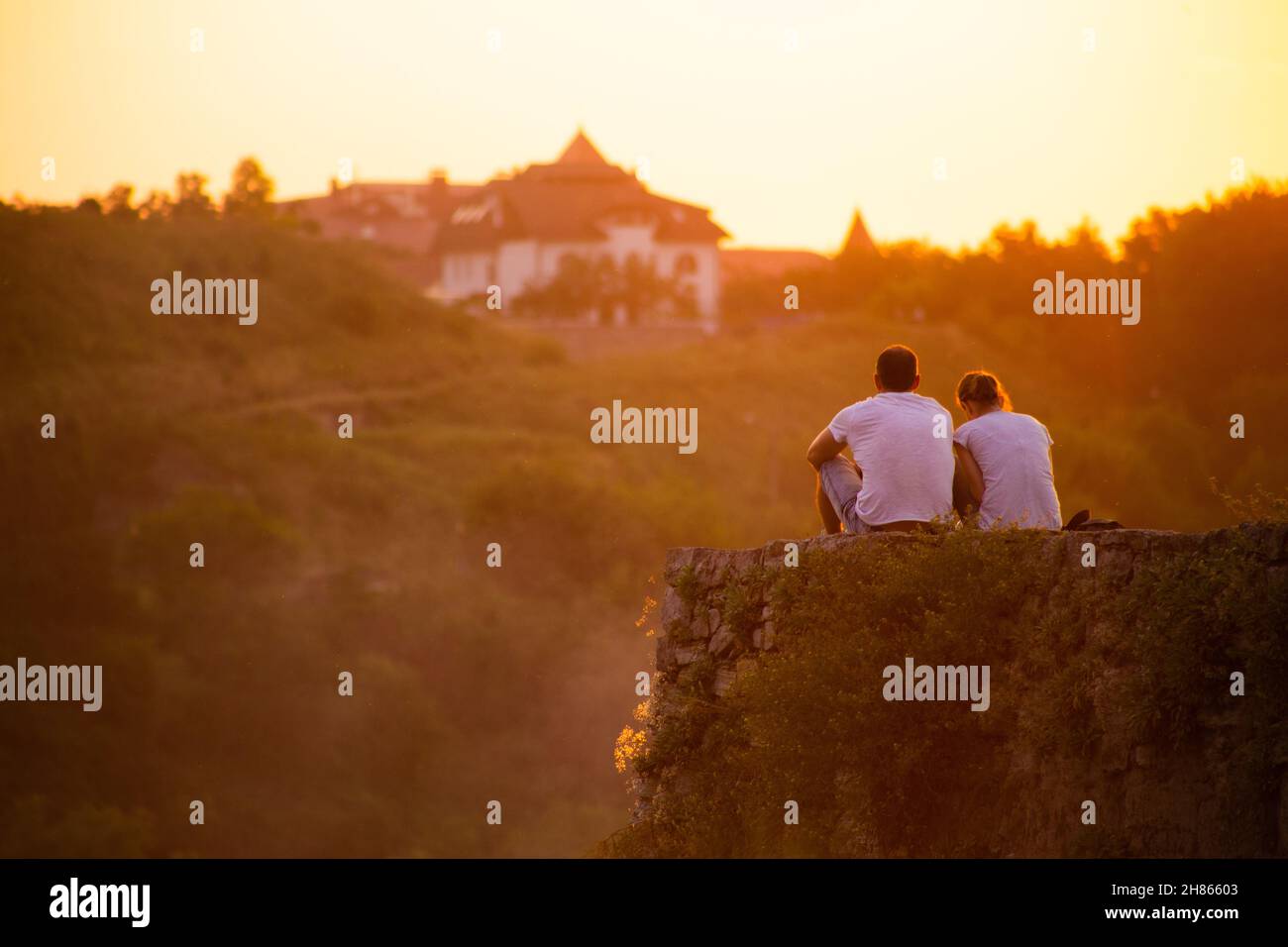Couple Sitting On Edge Cliff High Resolution Stock Photography and ...