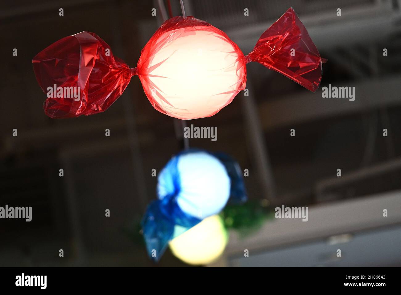 New York, USA. 27th Nov, 2021. Candy wrapper lamps hang from the ...