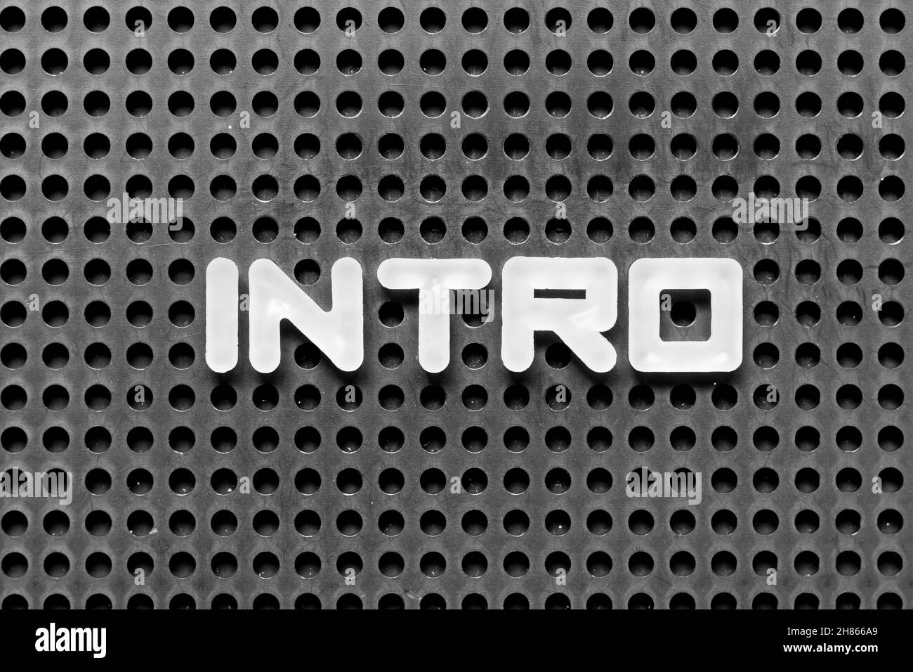 White alphabet letter in word intro on black pegboard background Stock ...