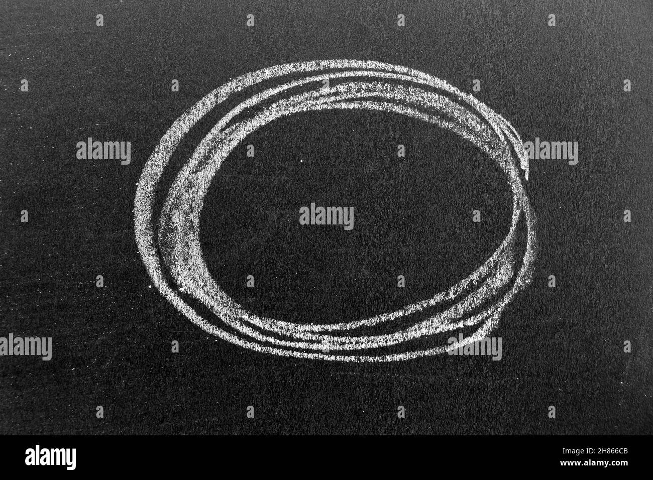 White chalk hand drawing as circle shape on black board background ...