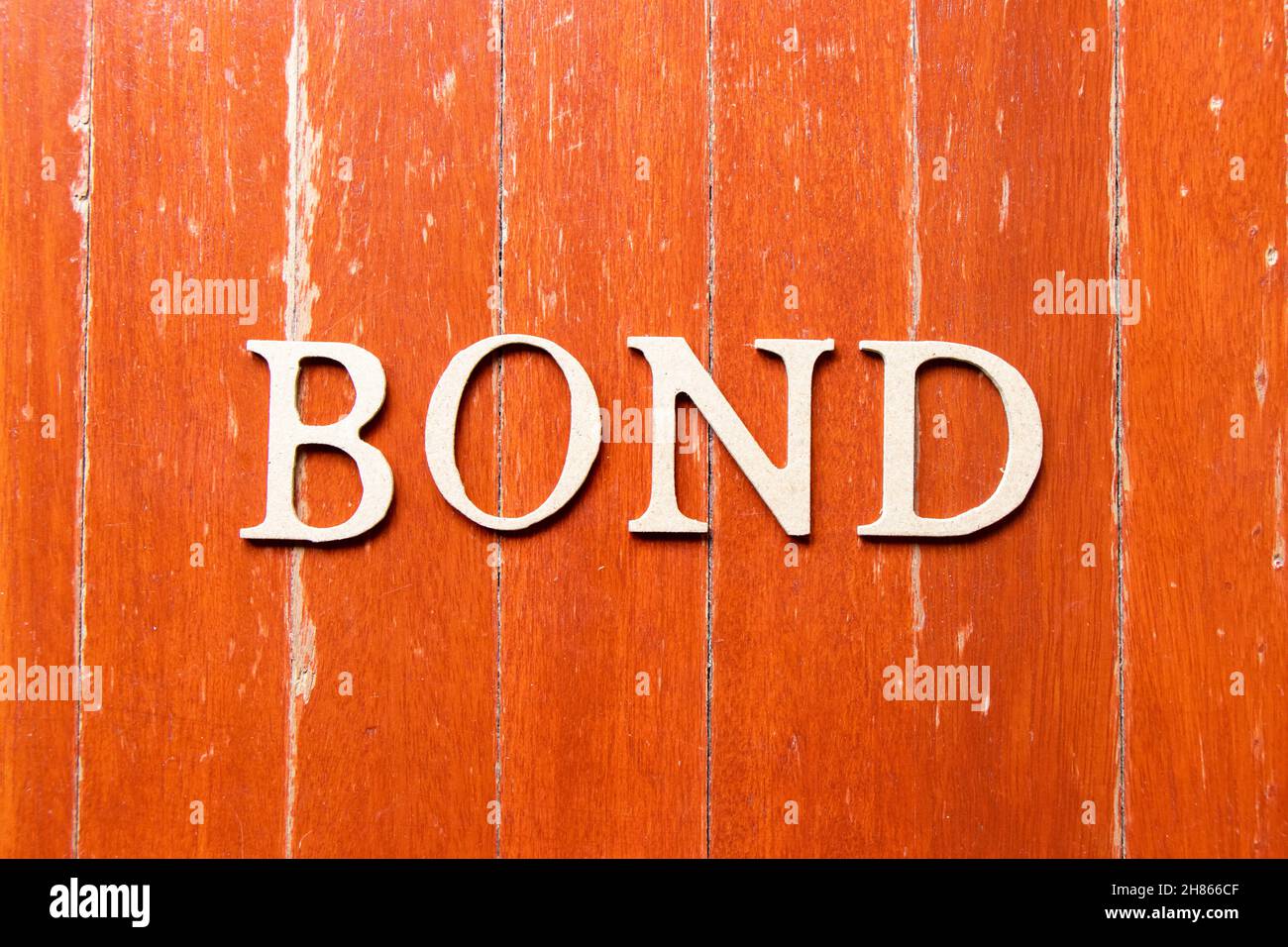 Alphabet letter in word bond on old red color wood plate background ...