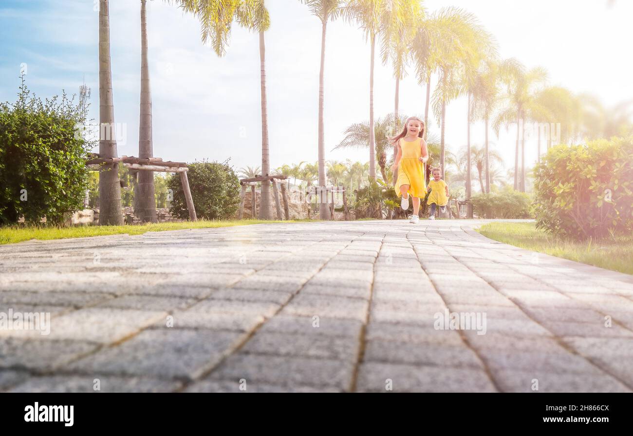 Happy family running in park hi-res stock photography and images - Alamy