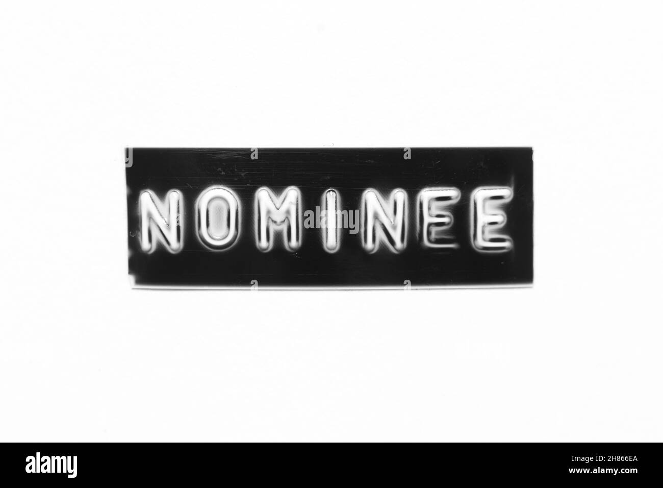 Black color banner that have embossed letter with word nominee on white ...