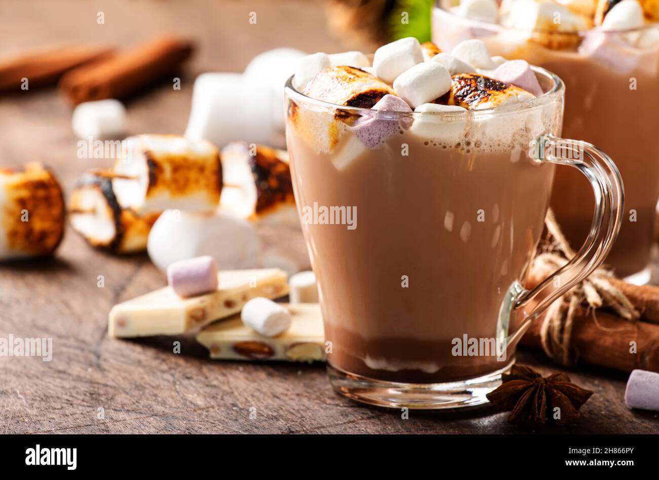 Hot chocolate drink with fried marshmallow in glass cups and winter ...