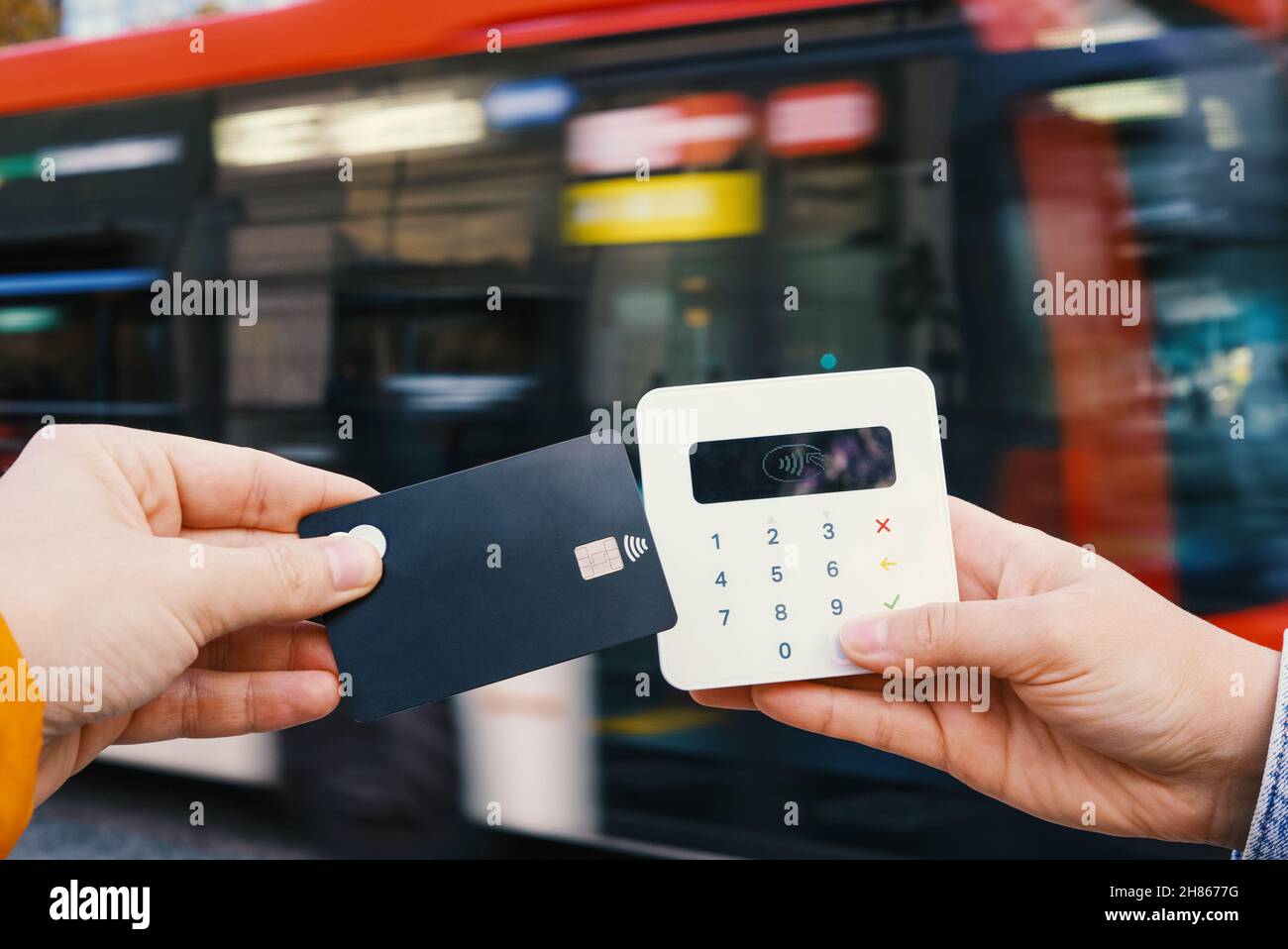 Crop faceless male passenger making NFC contactless payment for bus ...