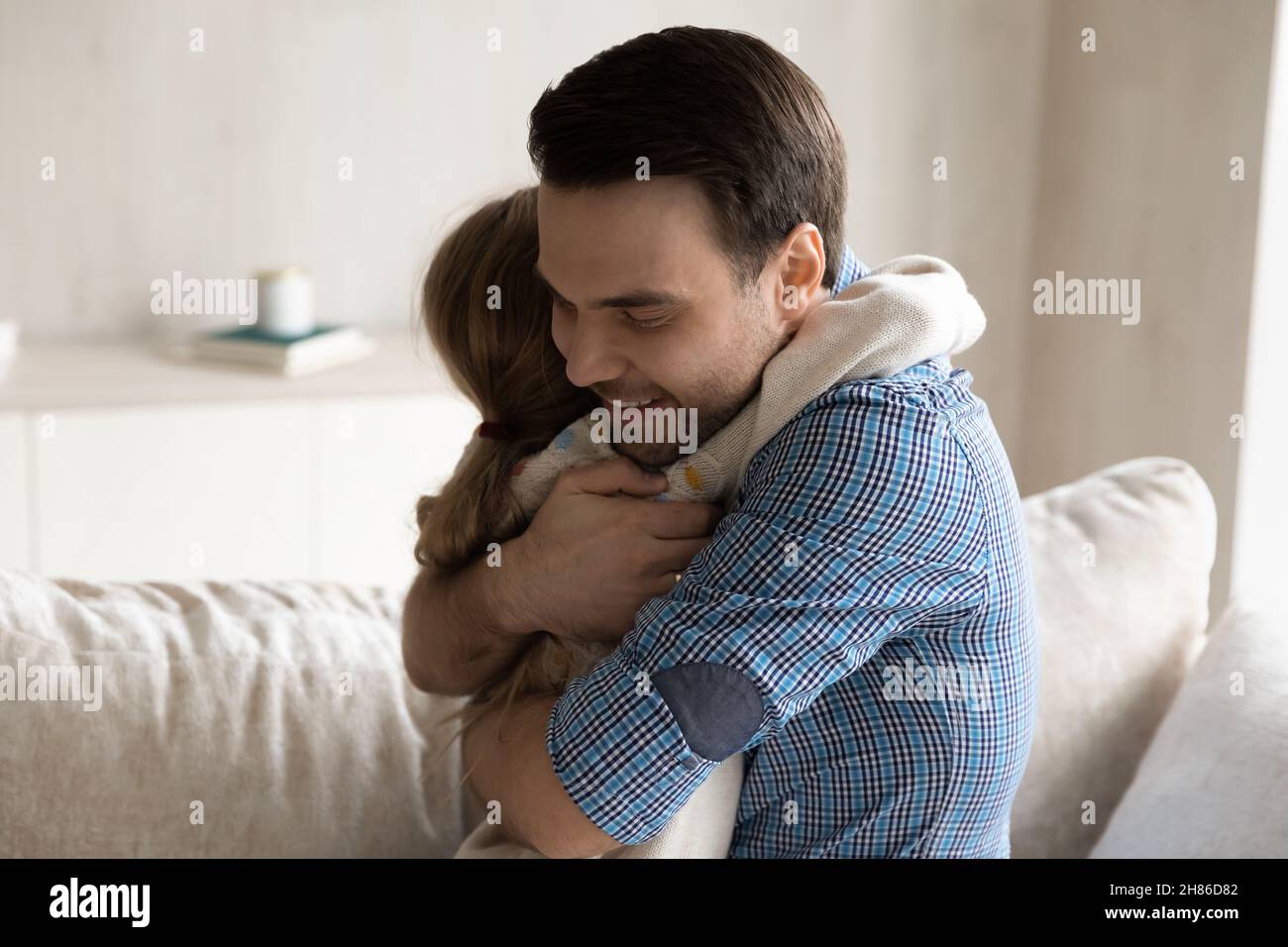 Happy young father cuddling little kid daughter Stock Photo - Alamy