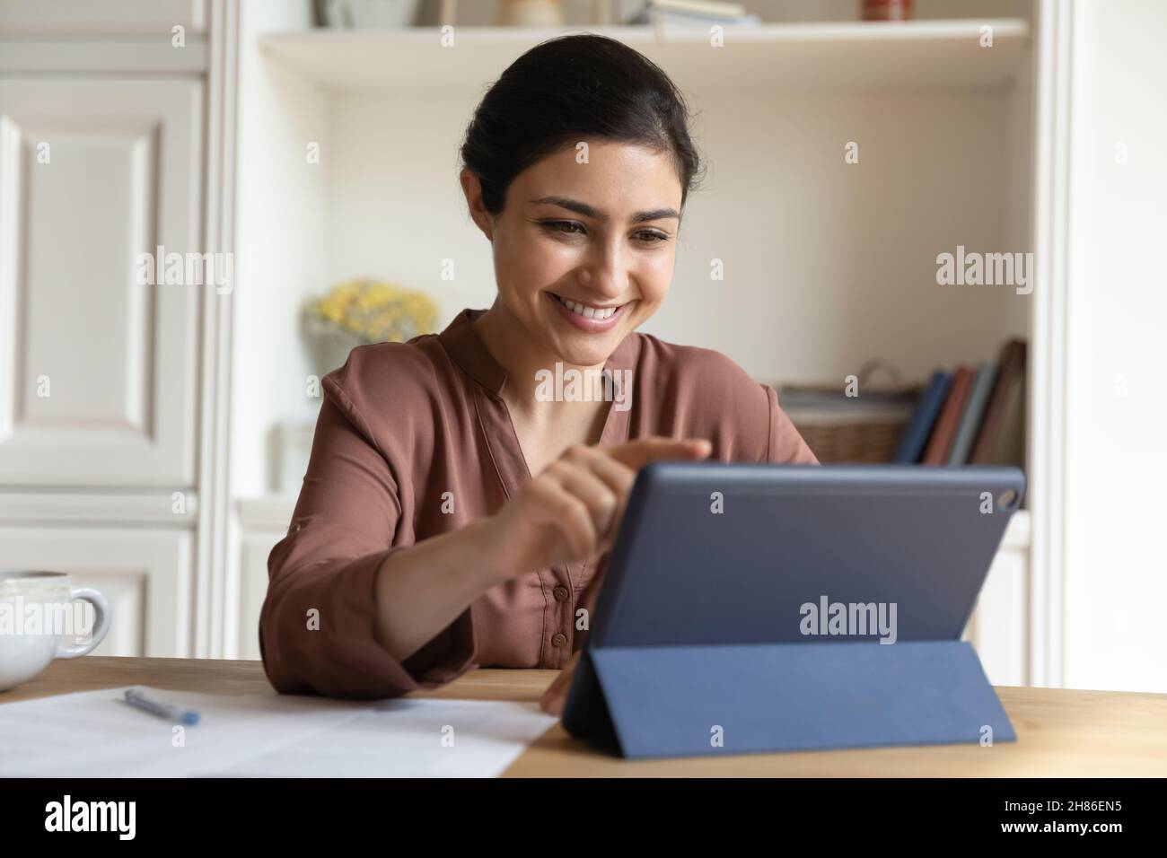 Happy indian woman using digital computer tablet Stock Photo - Alamy