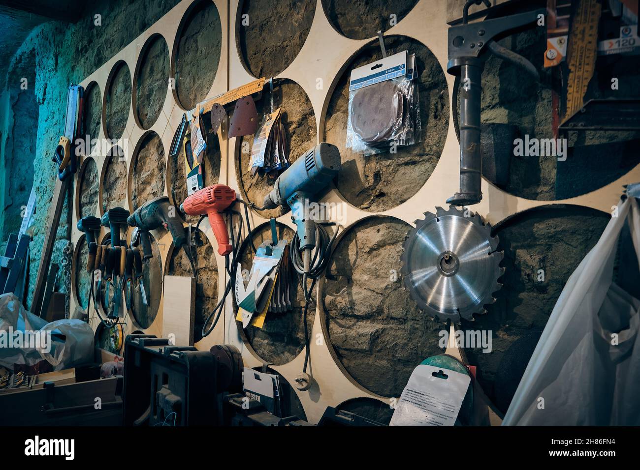 Carpentry instruments hang on wall Stock Photo - Alamy