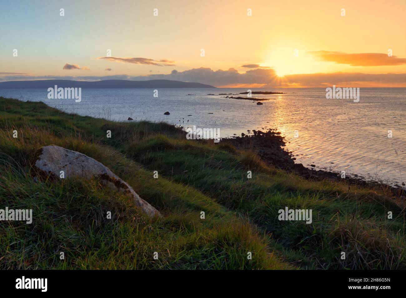 Beautiful seascape sunset scenery of rocky coast at wild atlantic way ...