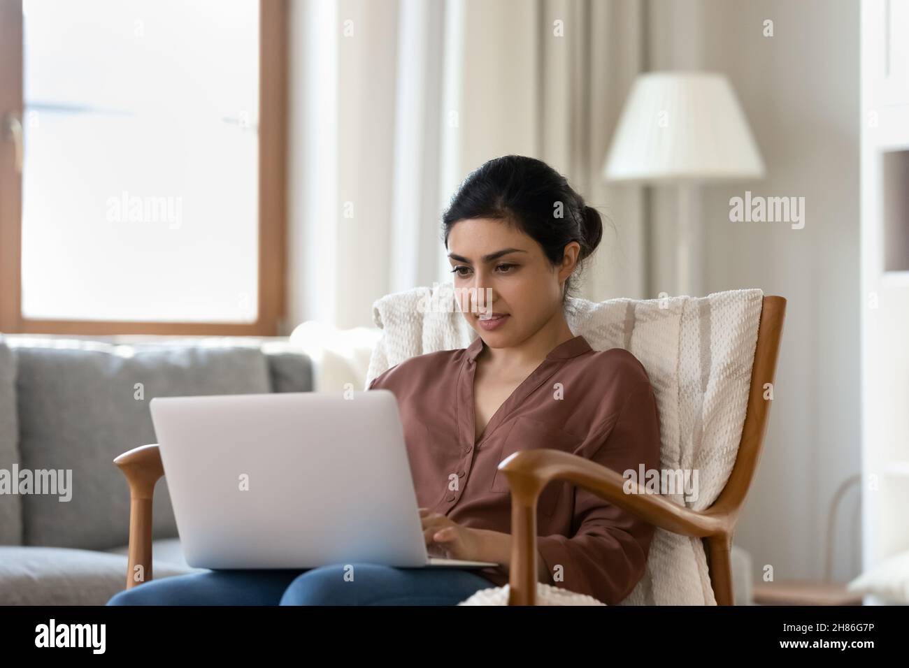 Happy young indian woman typing email on computer Stock Photo - Alamy