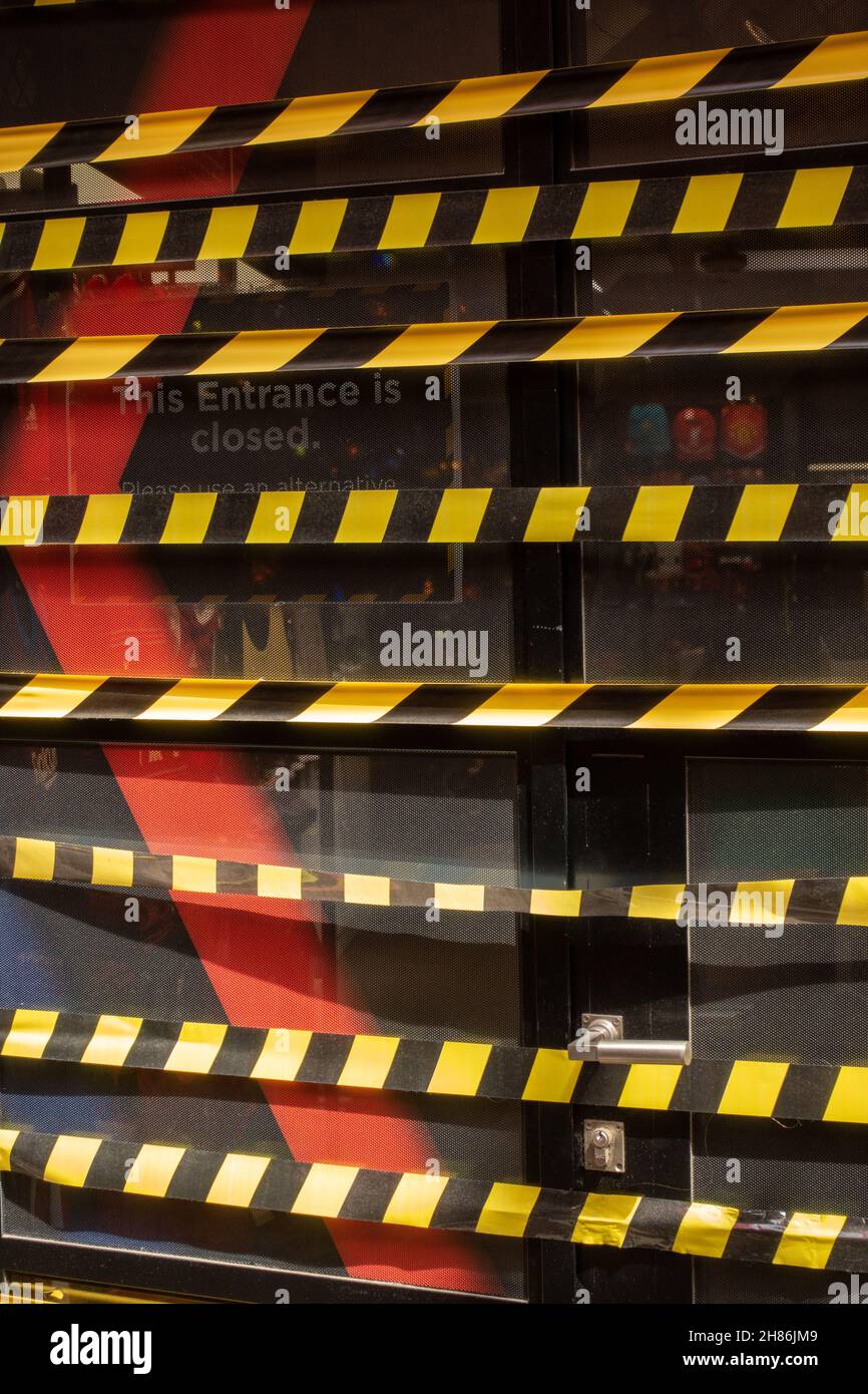 criss-cross tape blocking off a broken shop window in London Stock ...