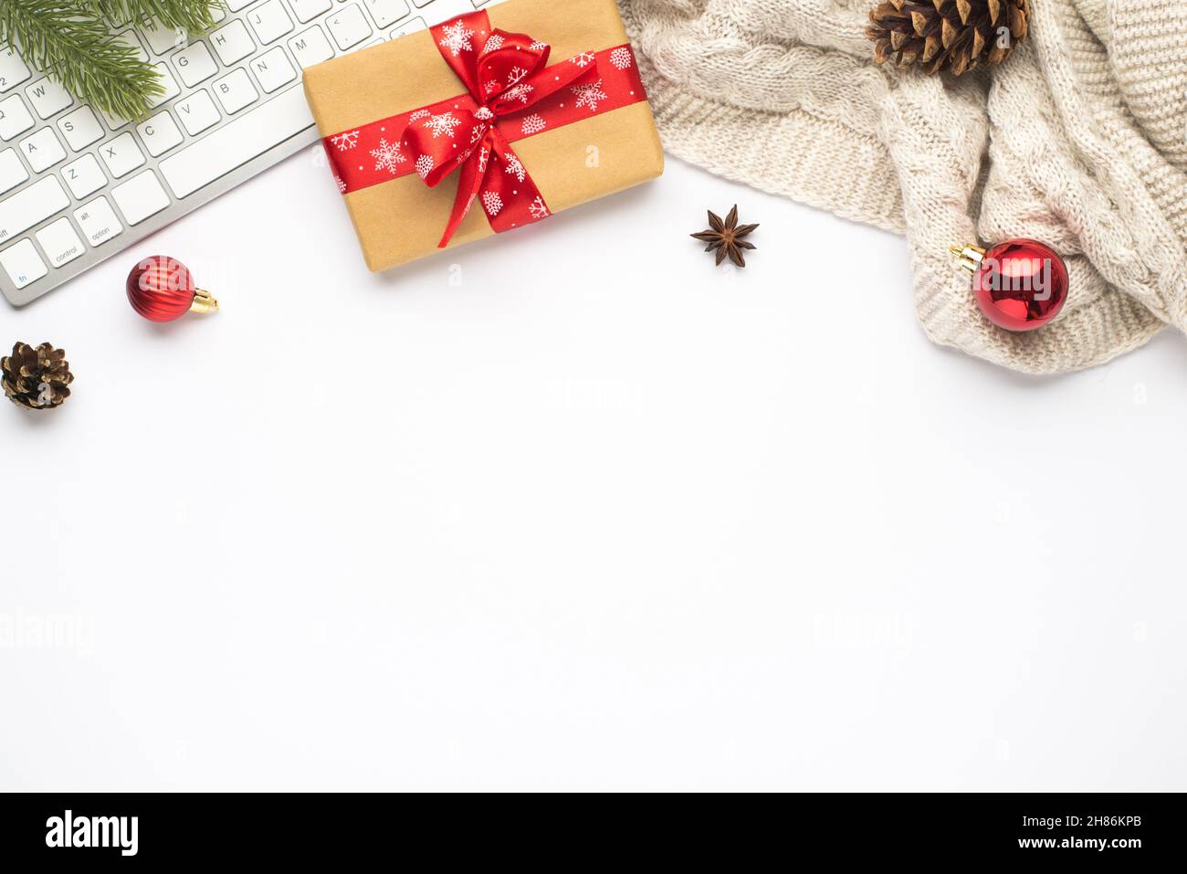 Top view photo of gift box with red bow keyboard red christmas tree ...
