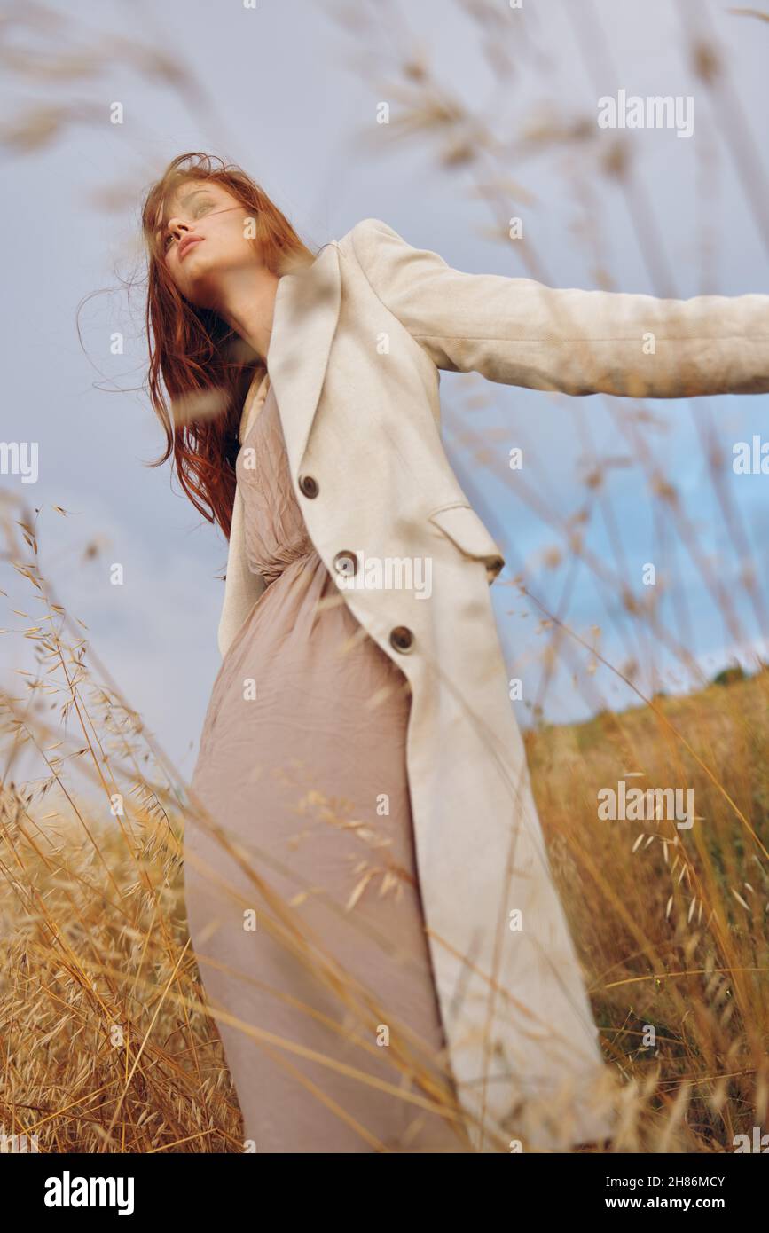 pretty woman coat outdoors walk endless field Stock Photo - Alamy