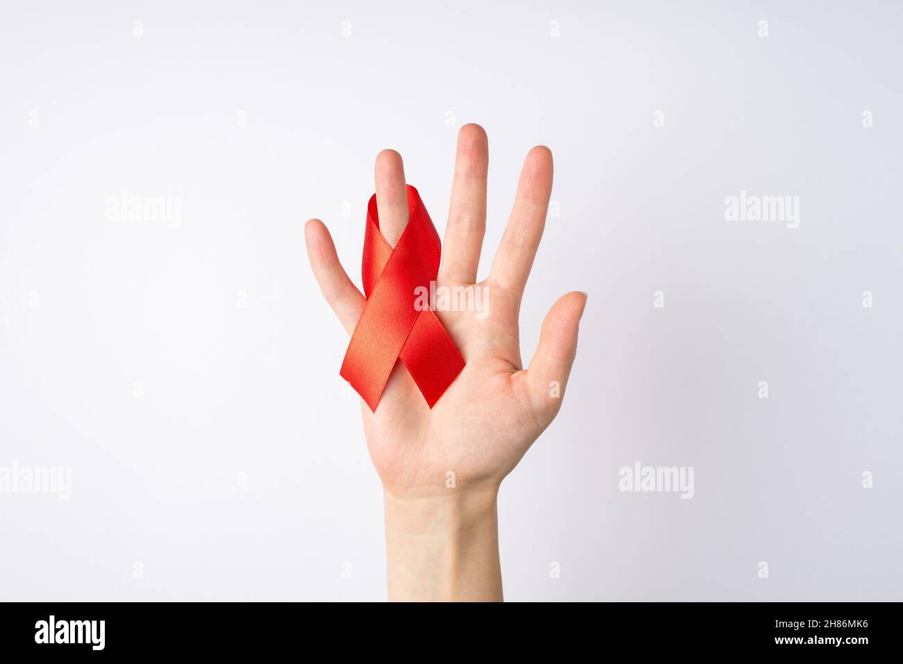 First person top view photo of female hand with red ribbon on ring ...
