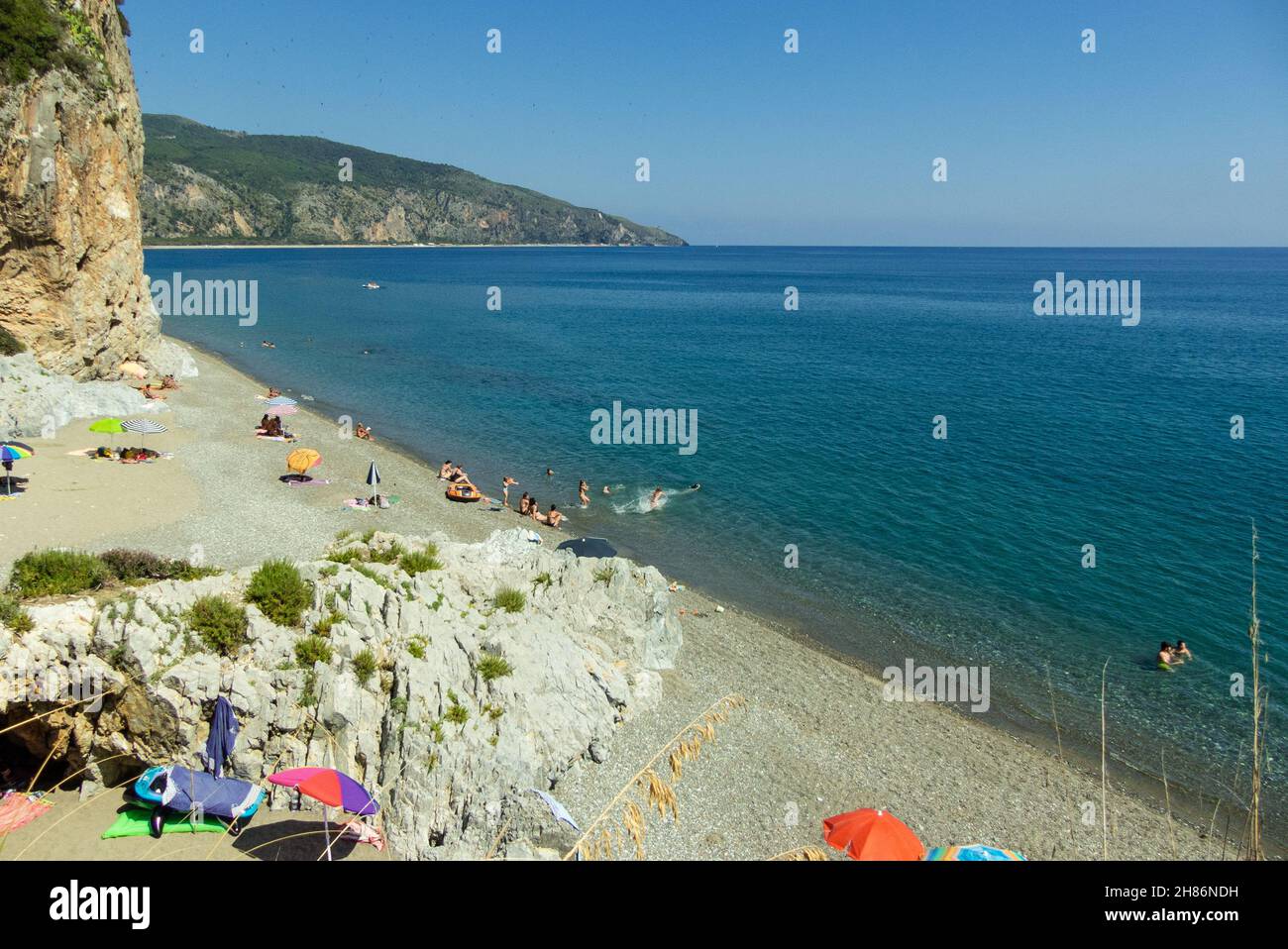 A beautiful scenery of blue water and rocky mountains under a sunny sky ...