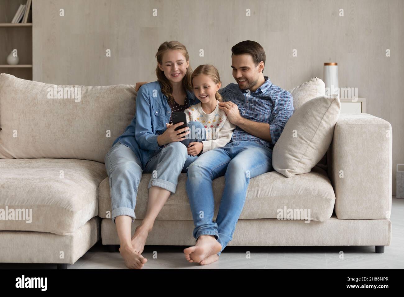 Addicted to modern tech happy family using cellphone Stock Photo - Alamy
