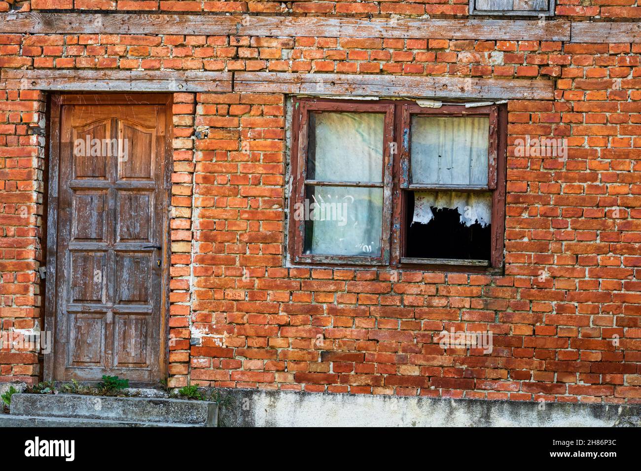 Old and abandoned brick house with broken windows Stock Photo - Alamy