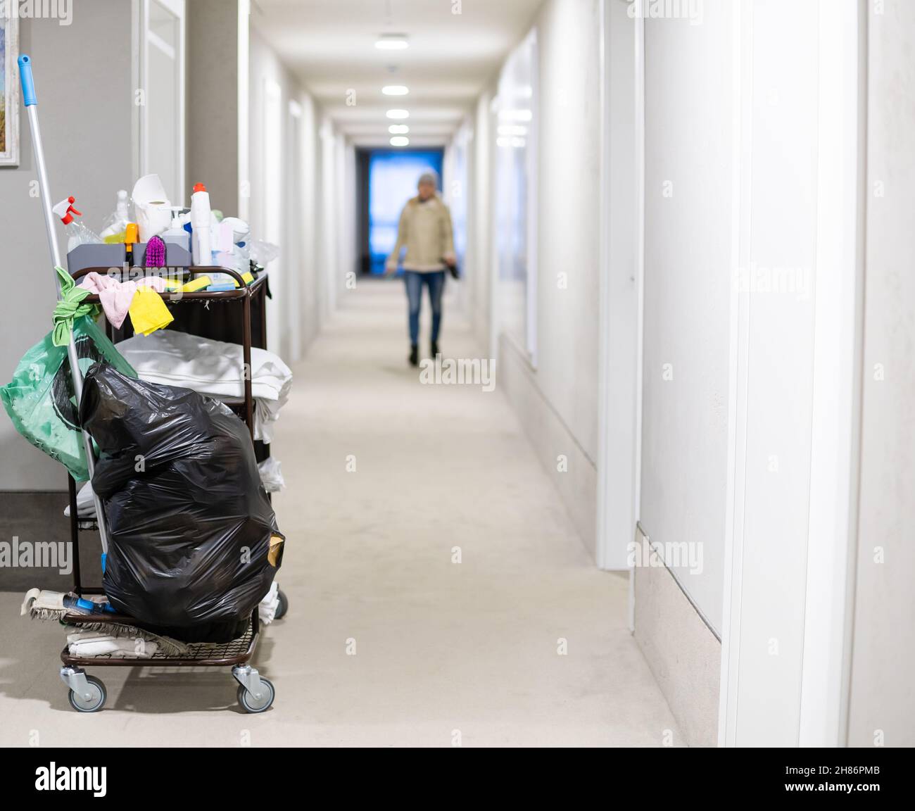 Cleaning utility janitorial cart in hotel corridor Stock Photo - Alamy