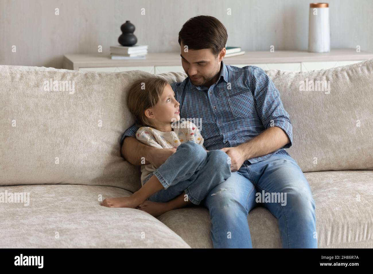 Affectionate millennial single father talking with kid daughter Stock ...