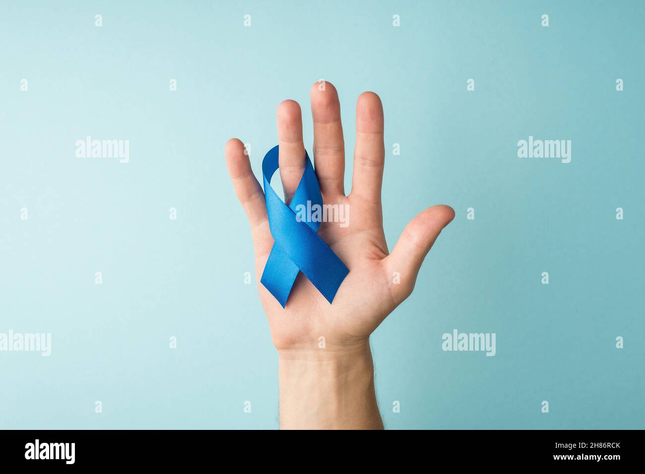 First person top view photo of male hand with blue ribbon on ring ...