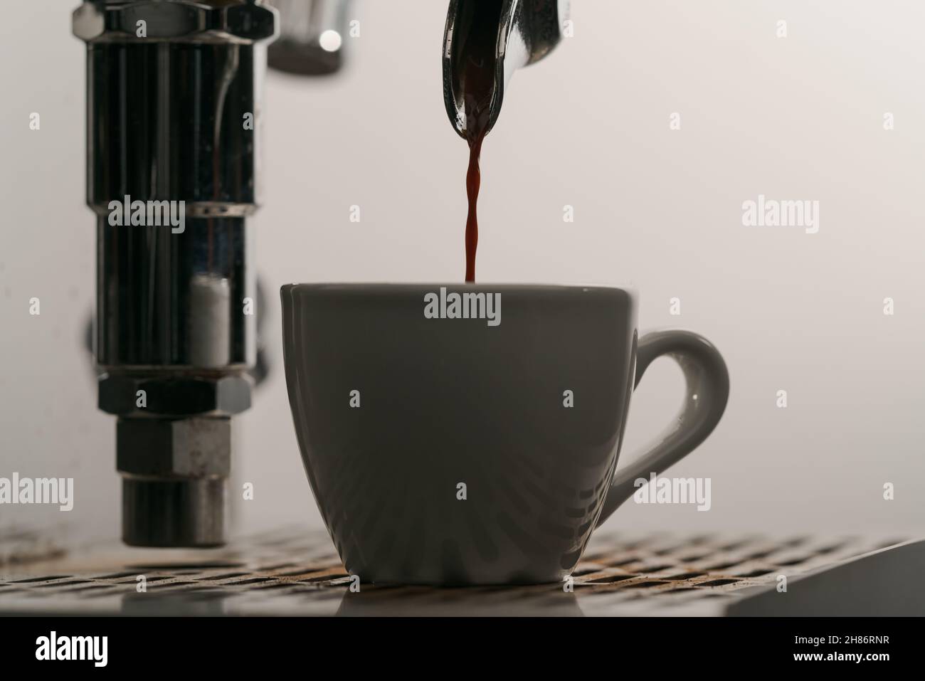 pulling espresso shot with single spout portafilter from coffee machine ...