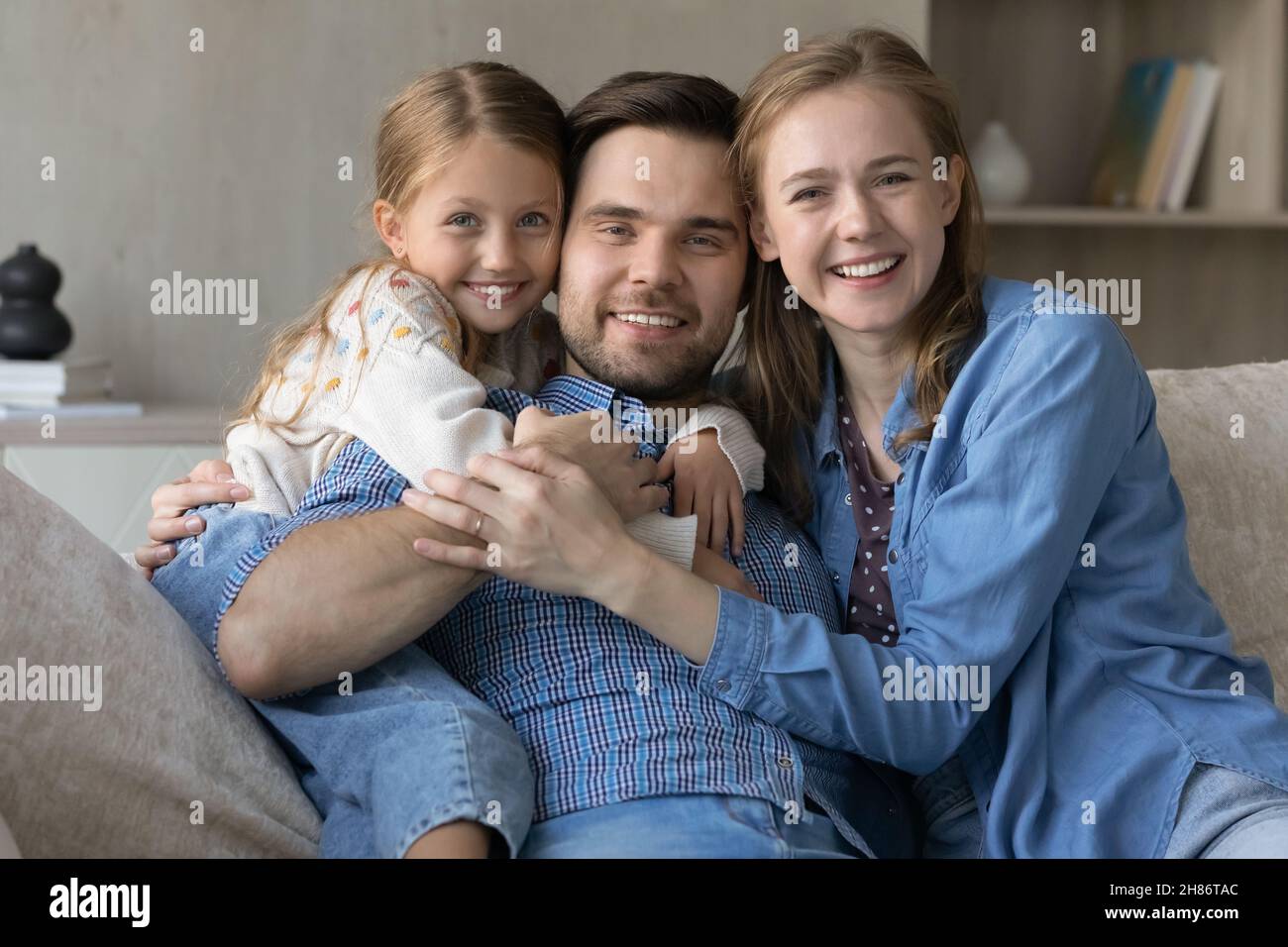 Portrait of relaxed millennial parents and little daughter Stock Photo ...
