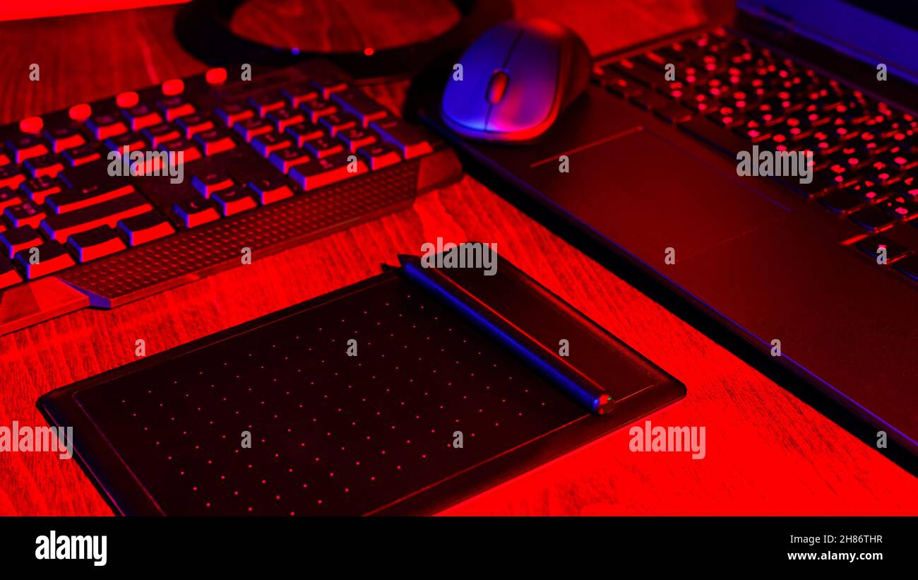 Graphic designer workplace in neon light. Computer equipment and ...