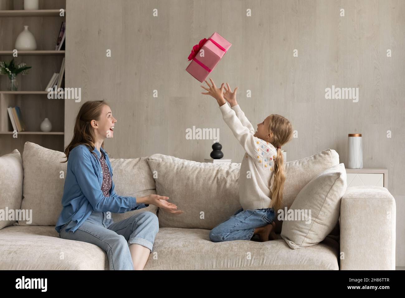 Happy little girl feeling excited of getting present gift Stock Photo ...