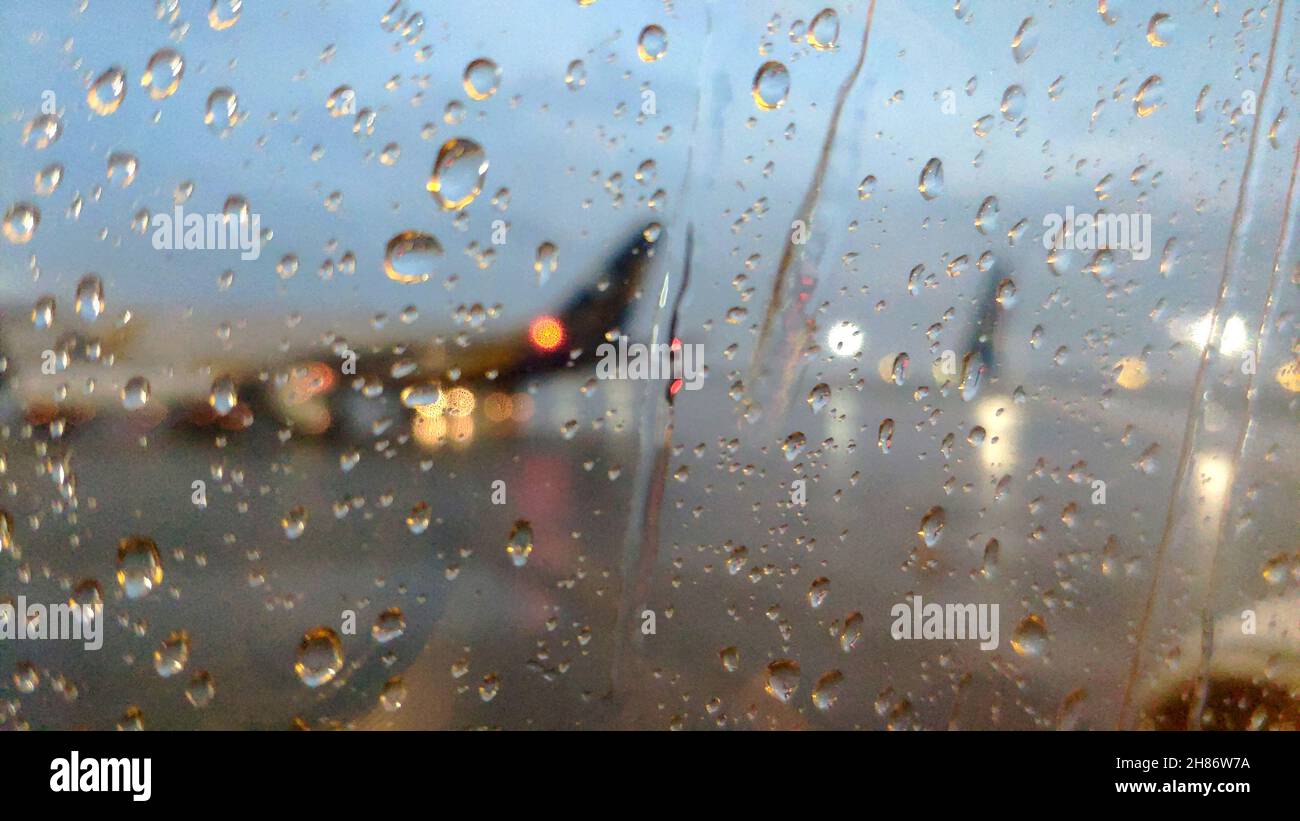 Rainy airplane field through the airplane window, abstract travel ...