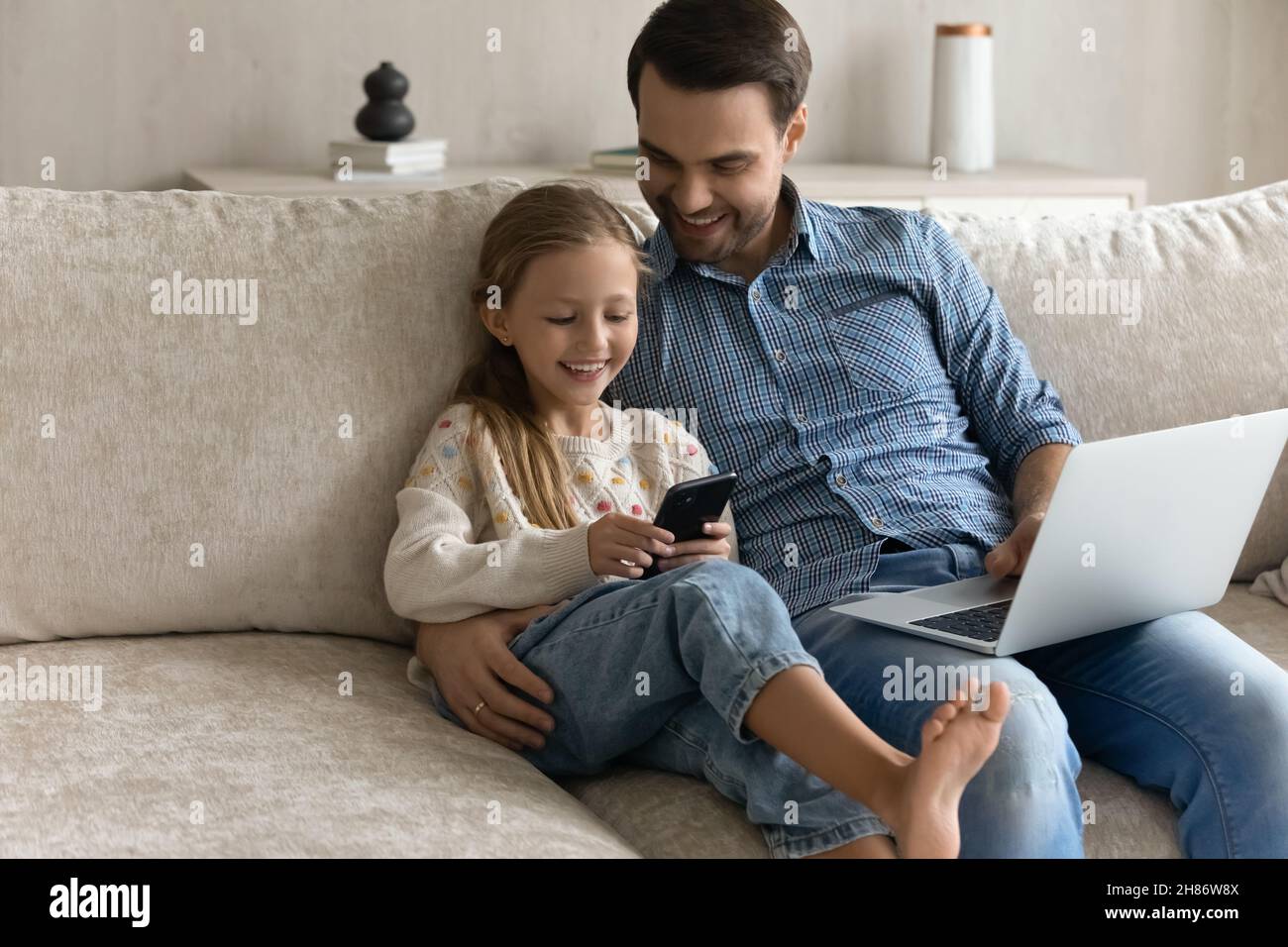 Addicted to modern tech happy family using different gadgets Stock ...