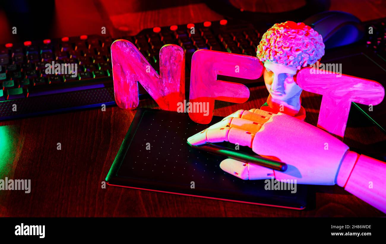 NFT (Non-Fungible token). Artificial hand creates crypto art using a ...