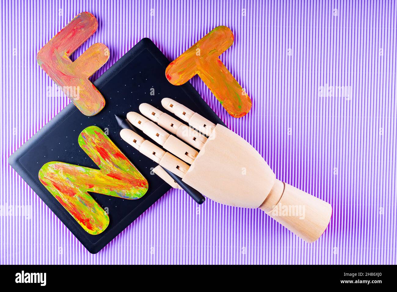 NFT (Non-Fungible token). Artificial hand creates crypto art using a ...