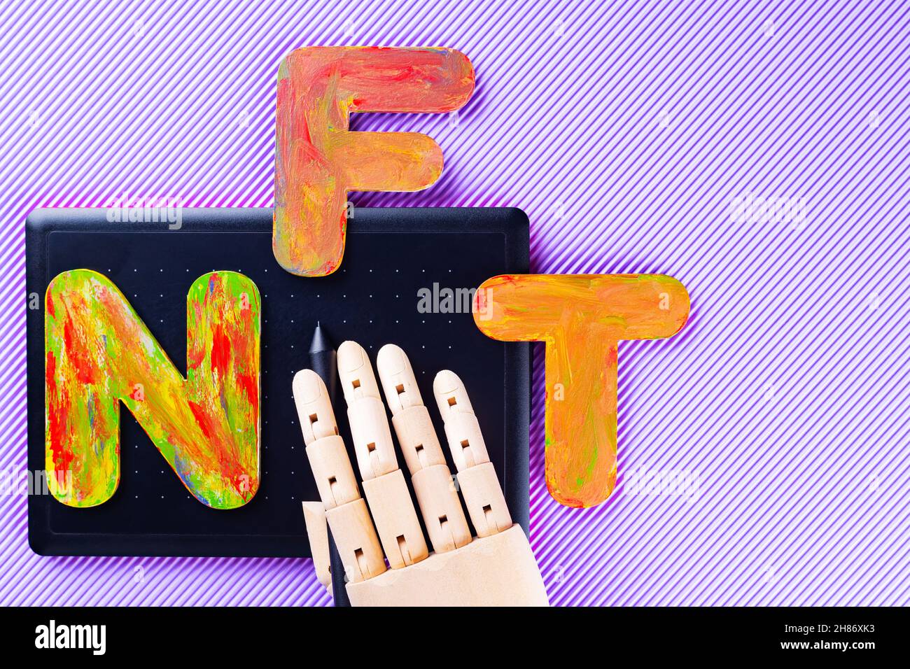 NFT (Non-Fungible token). Artificial hand creates crypto art using a ...