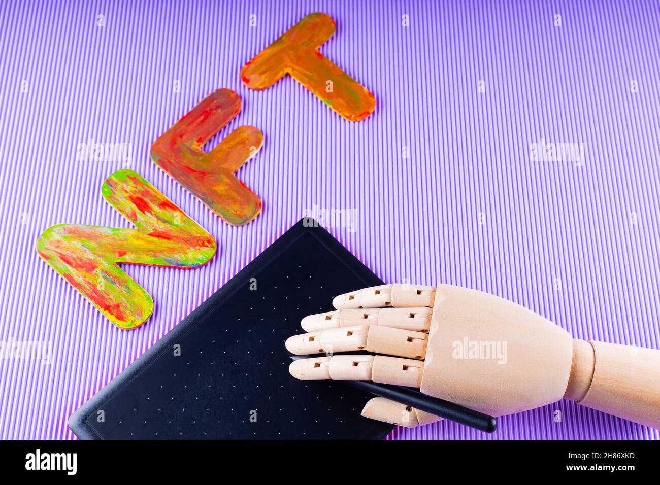 NFT (Non-Fungible token). Artificial hand creates crypto art using a ...