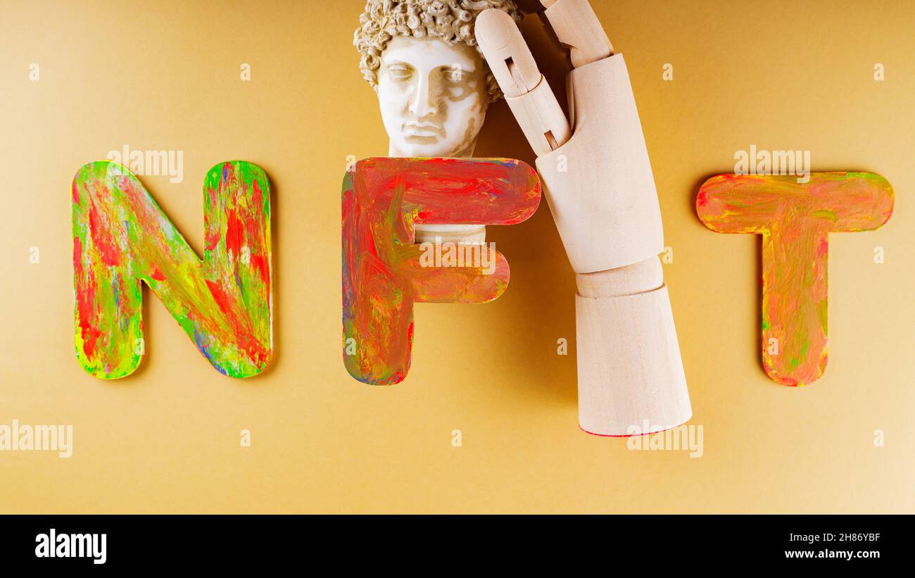 NFT (Non-Fungible token). Artificial fingers hug the plaster head of ...