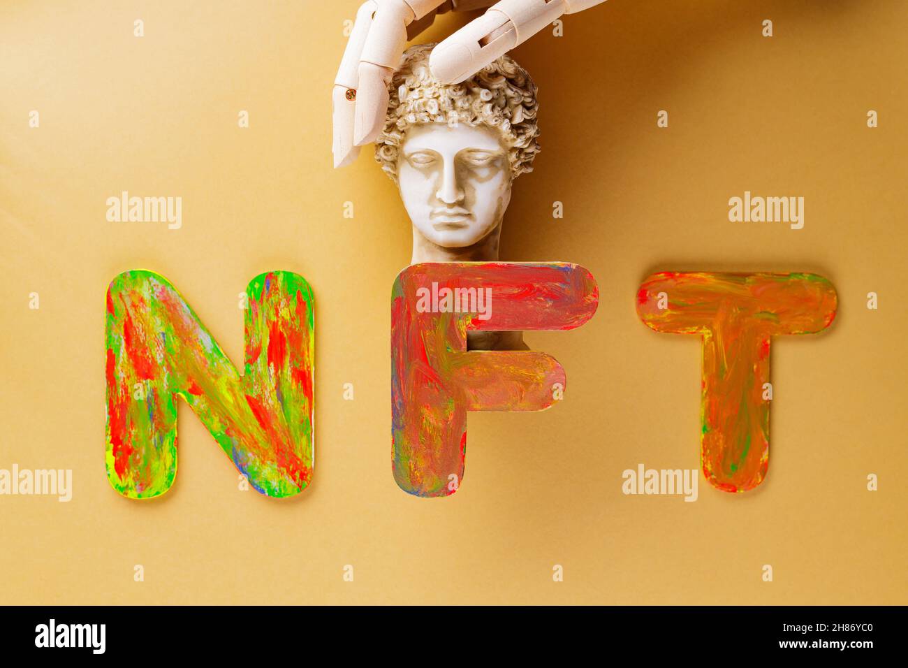 NFT (Non-Fungible token). Artificial fingers hug the plaster head of ...