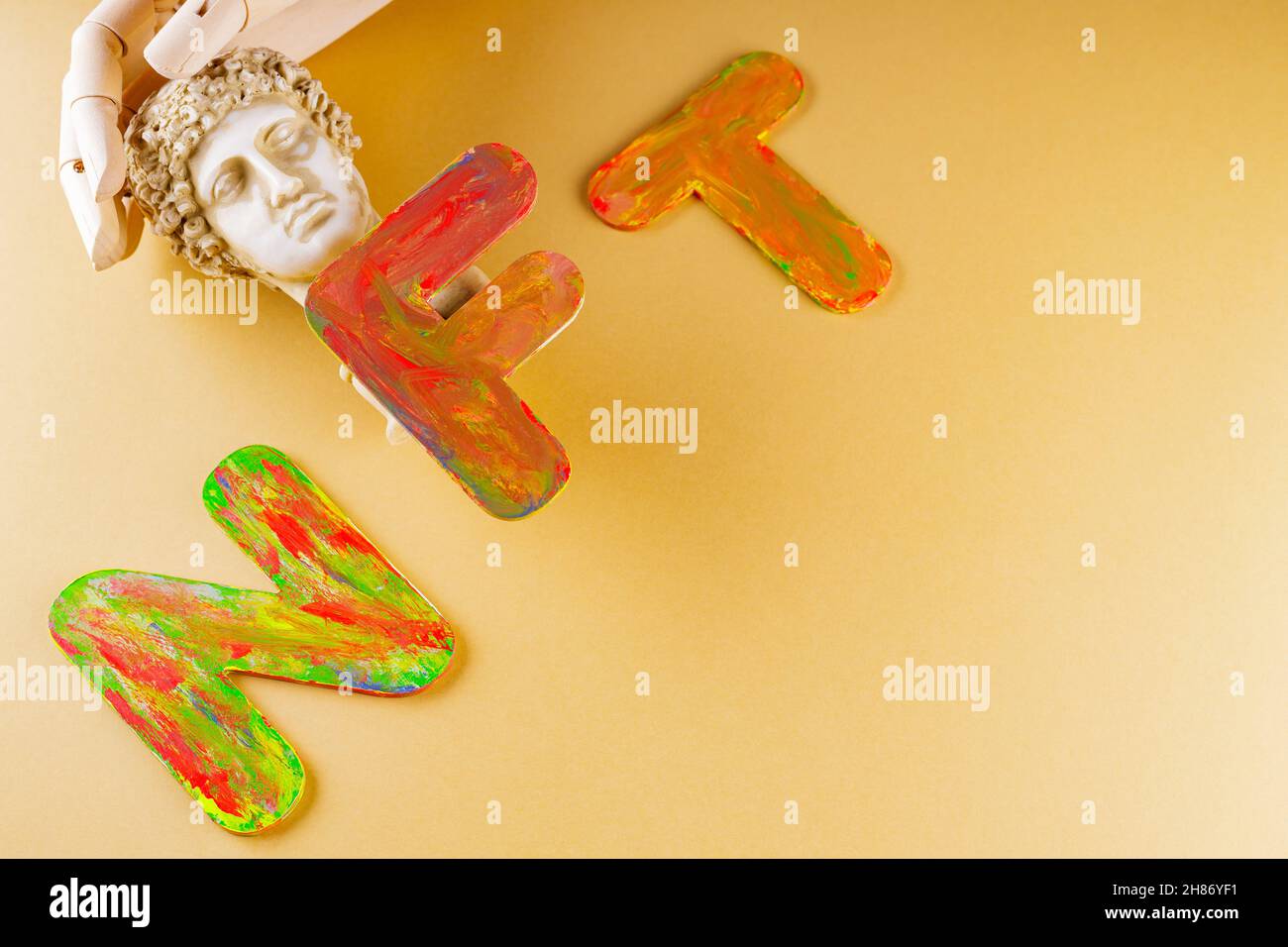 NFT (Non-Fungible token). Artificial fingers hug the plaster head of ...