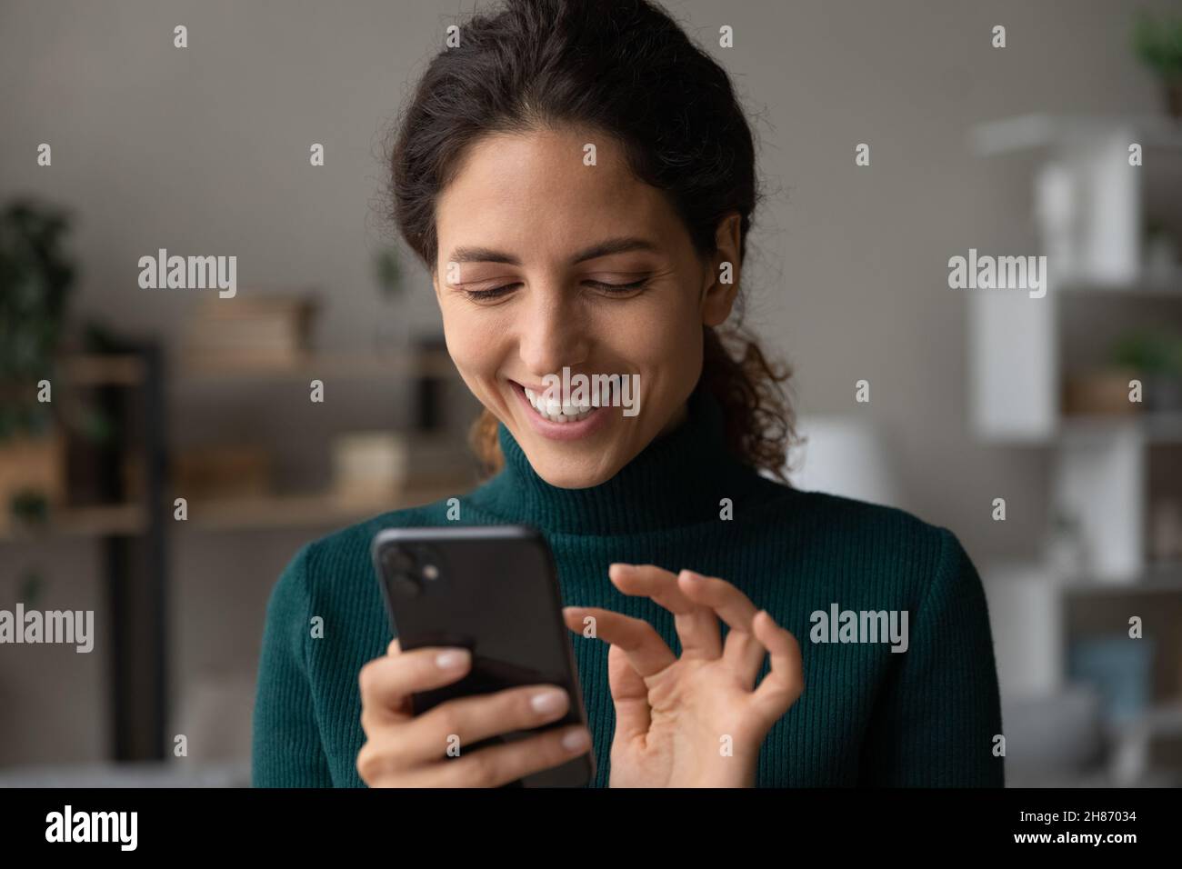 Smiling latina lady touch smartphone screen text answer on message ...