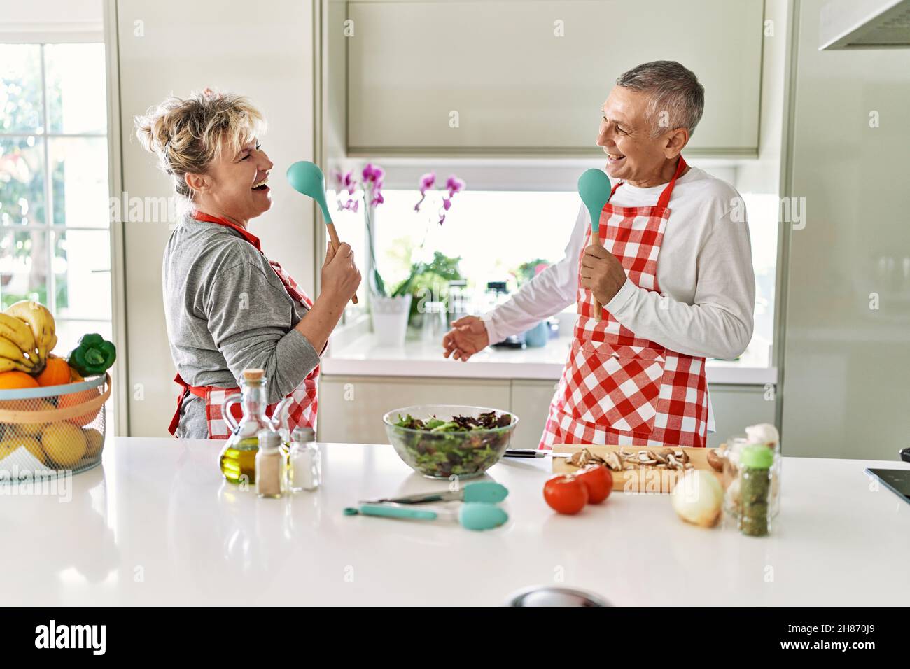 Senior caucasian couple smiling happy cooking at the kitchen Stock ...
