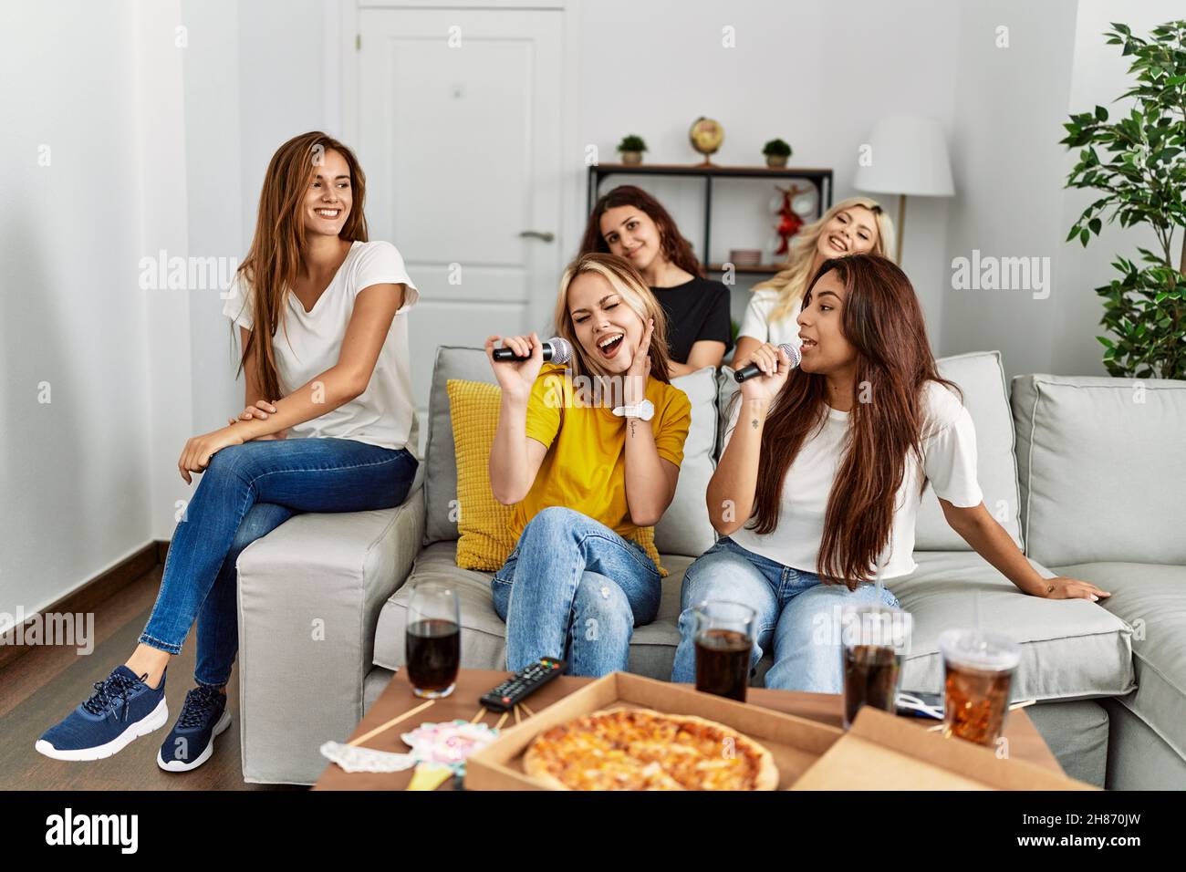 Group of young woman friends having party eating italian pizza and ...