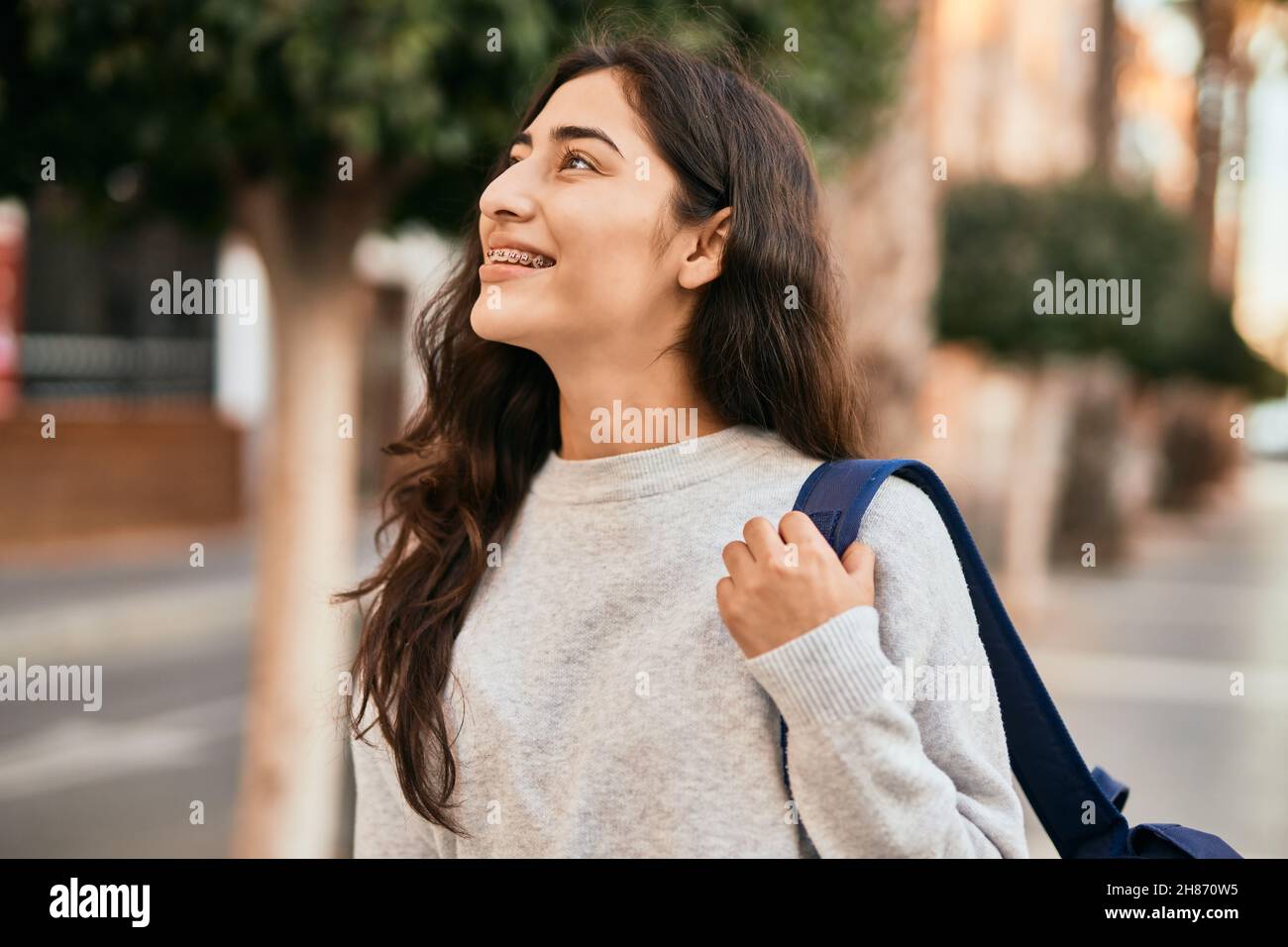 Young middle east student girl smiling happy standing at the city Stock ...