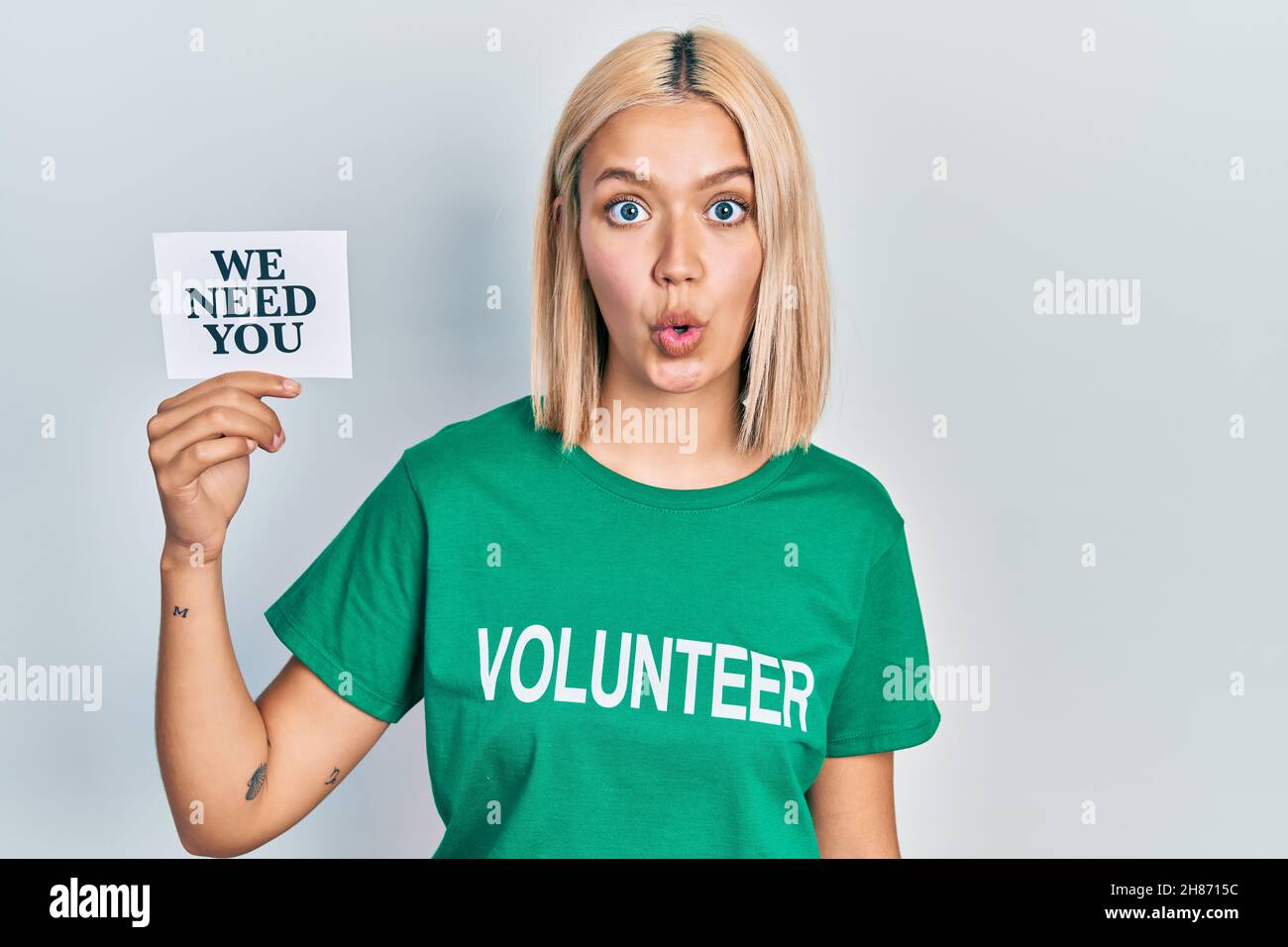 Beautiful blonde woman wearing volunteer t shirt showing we need you ...