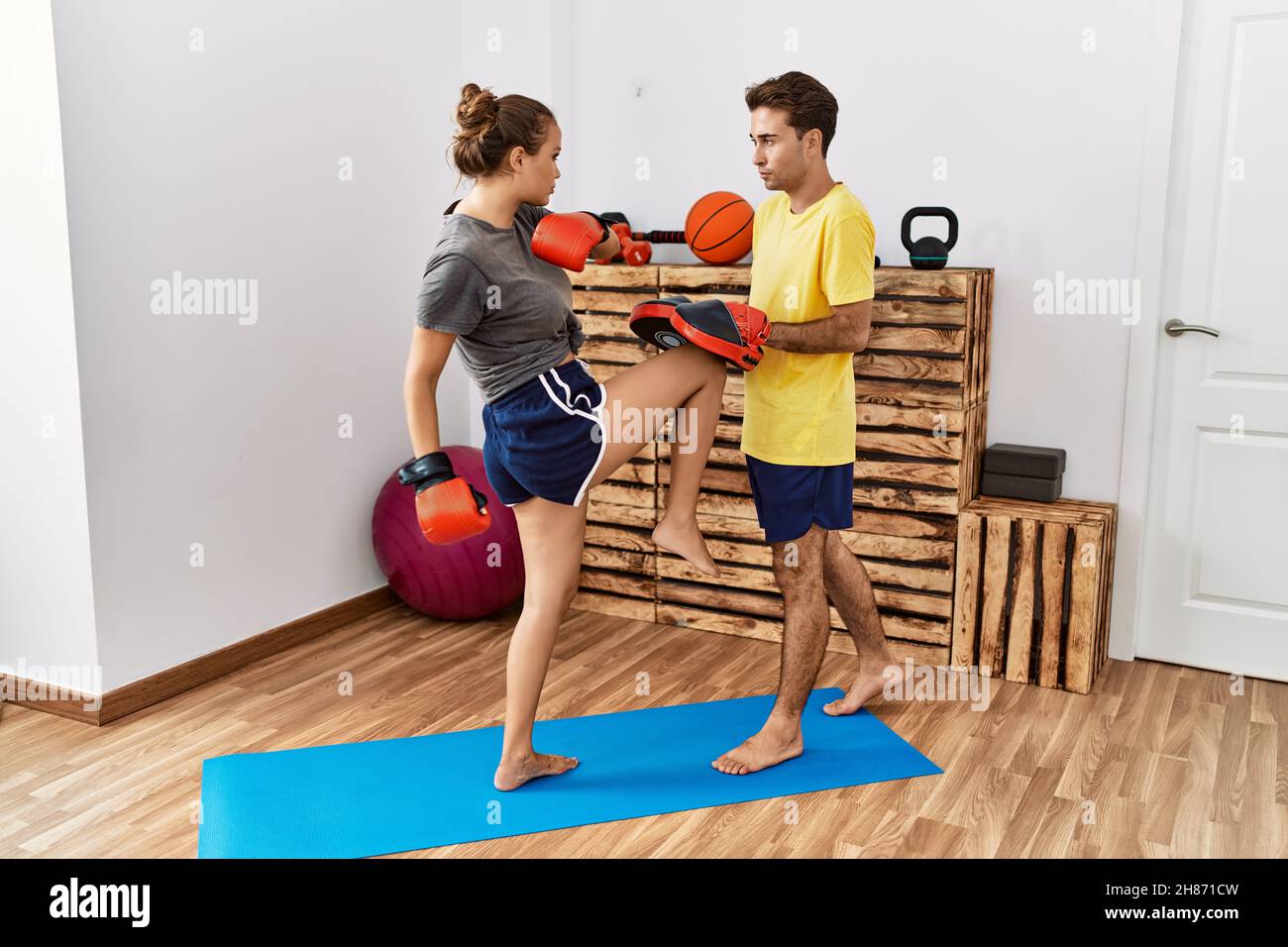 Man and woman couple smiling confident training kickboxing at sport ...