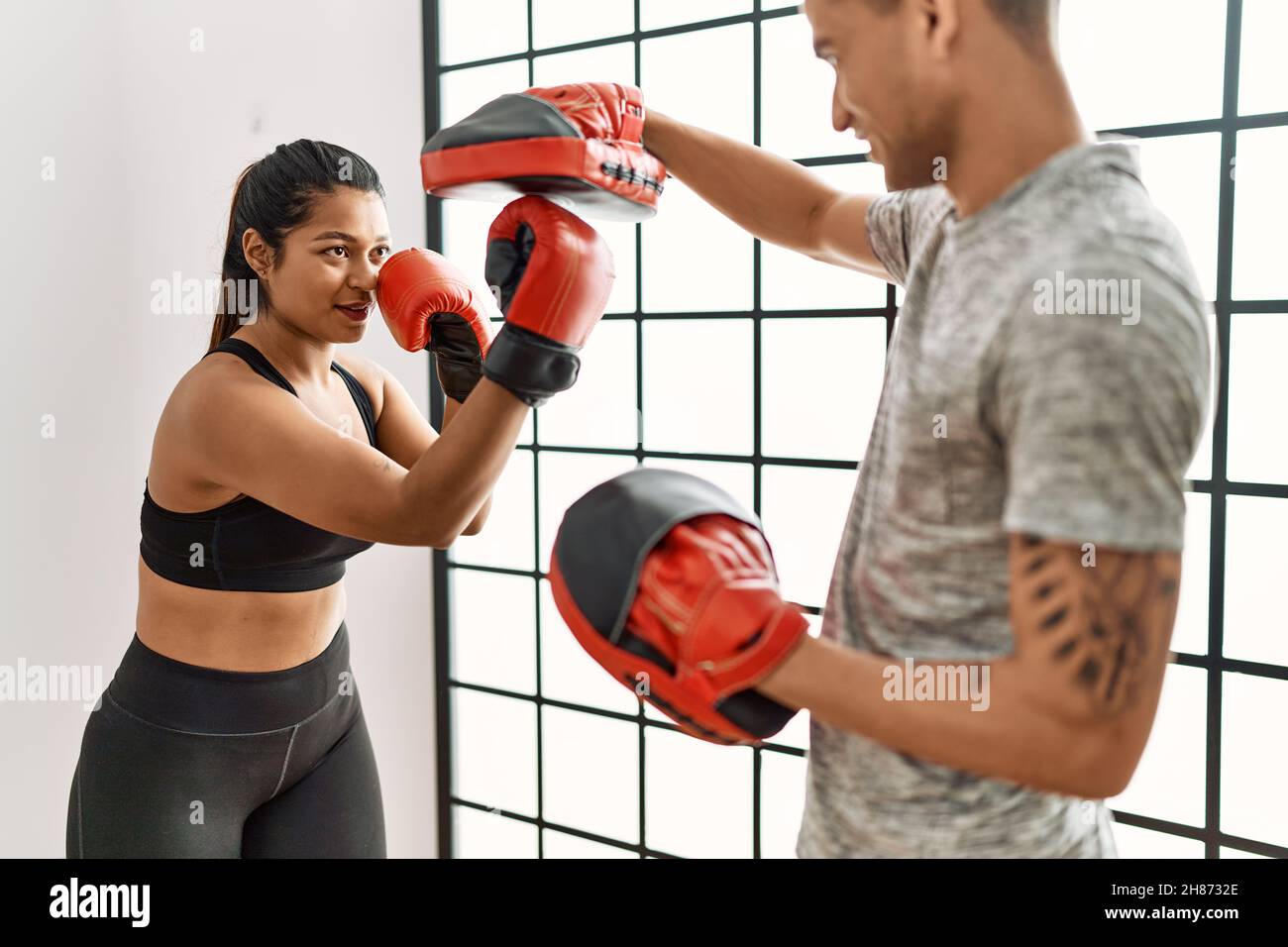 Young latin sporty couple smiling happy boxing at sport center Stock ...